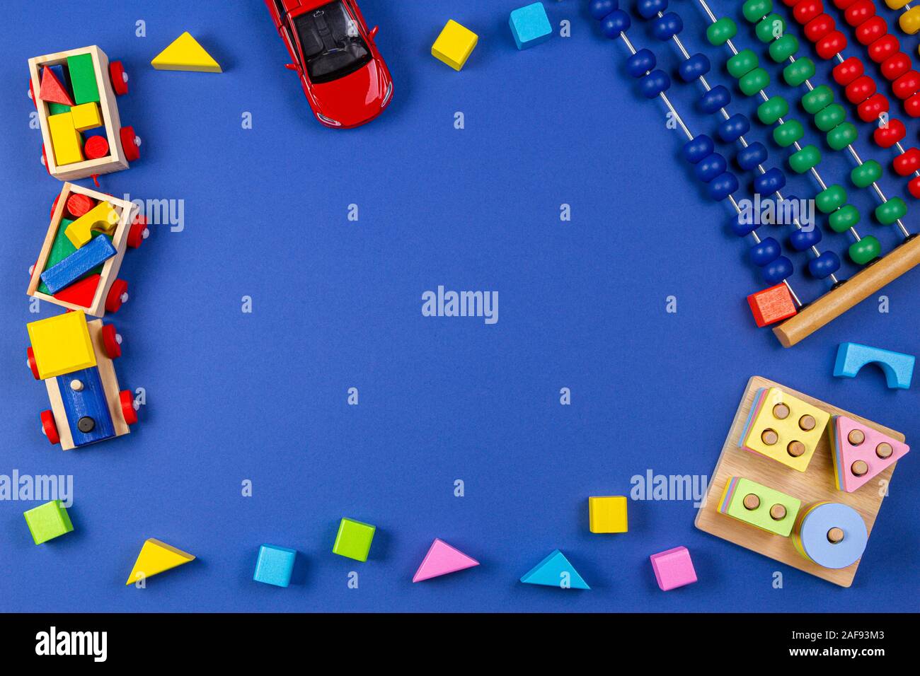 Baby kids toys background. Wooden educational toys on navy blue ...