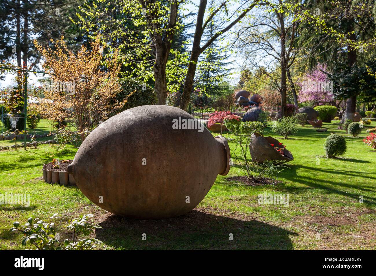 Landscape design in the Park, clay wine jug as a decoration, green ...