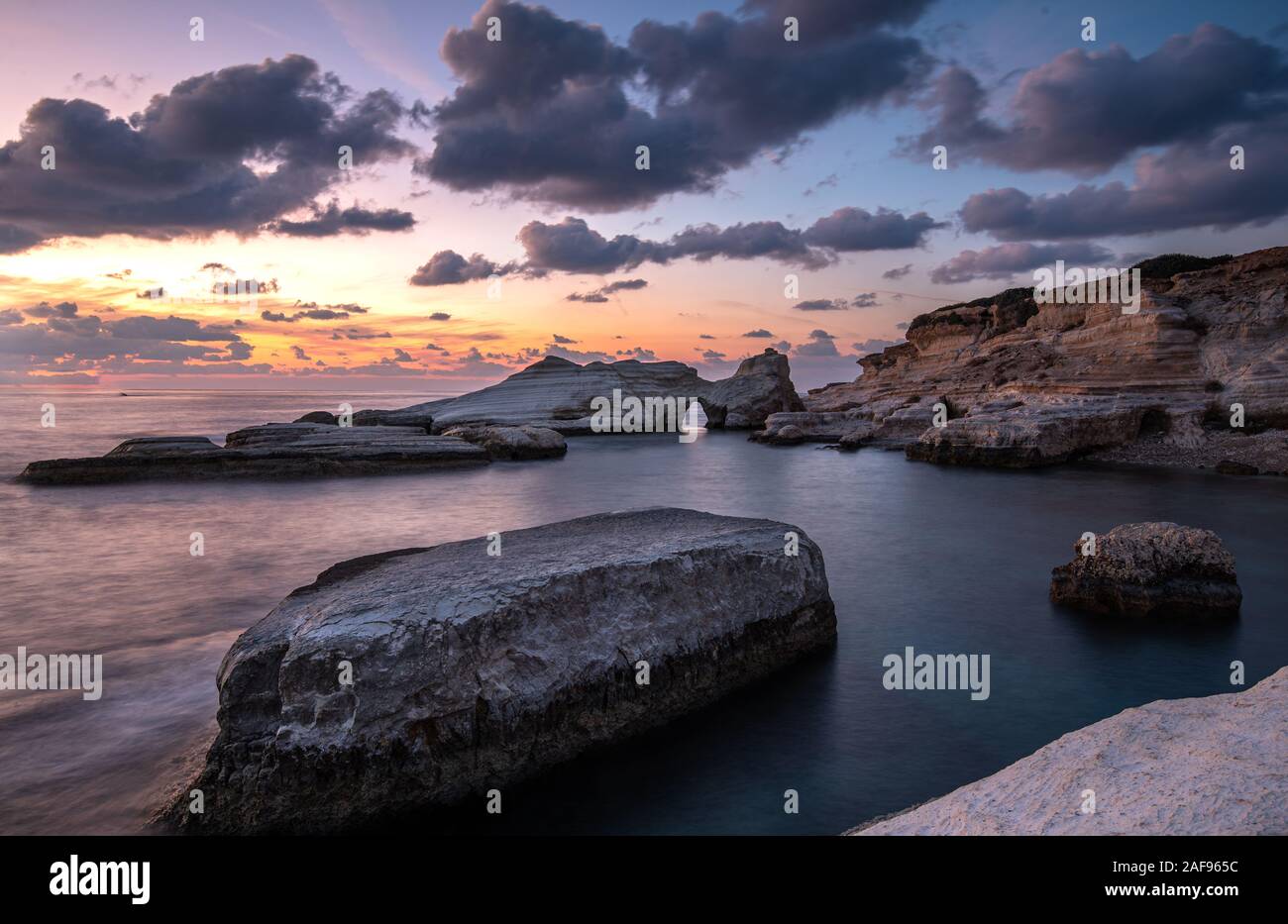 Rocky seashore seascape with wavy ocean and dramatic and beautiful ...