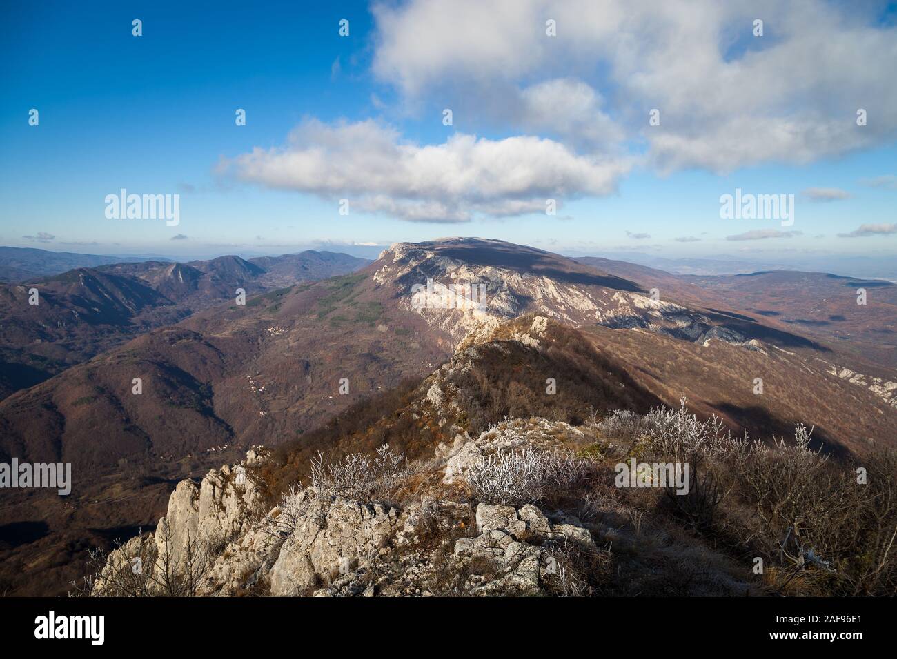 Beautiful rocky mountain peak, forests colored with late autumn colors ...