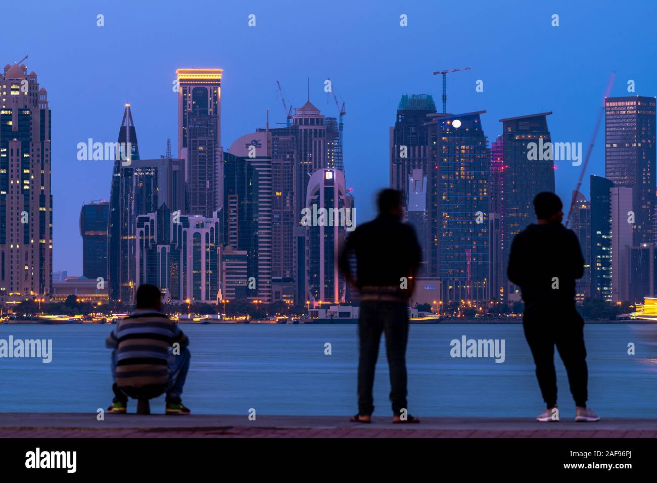 People at Doha Corniche at Doha Skyline in Background Stock Photo - Alamy