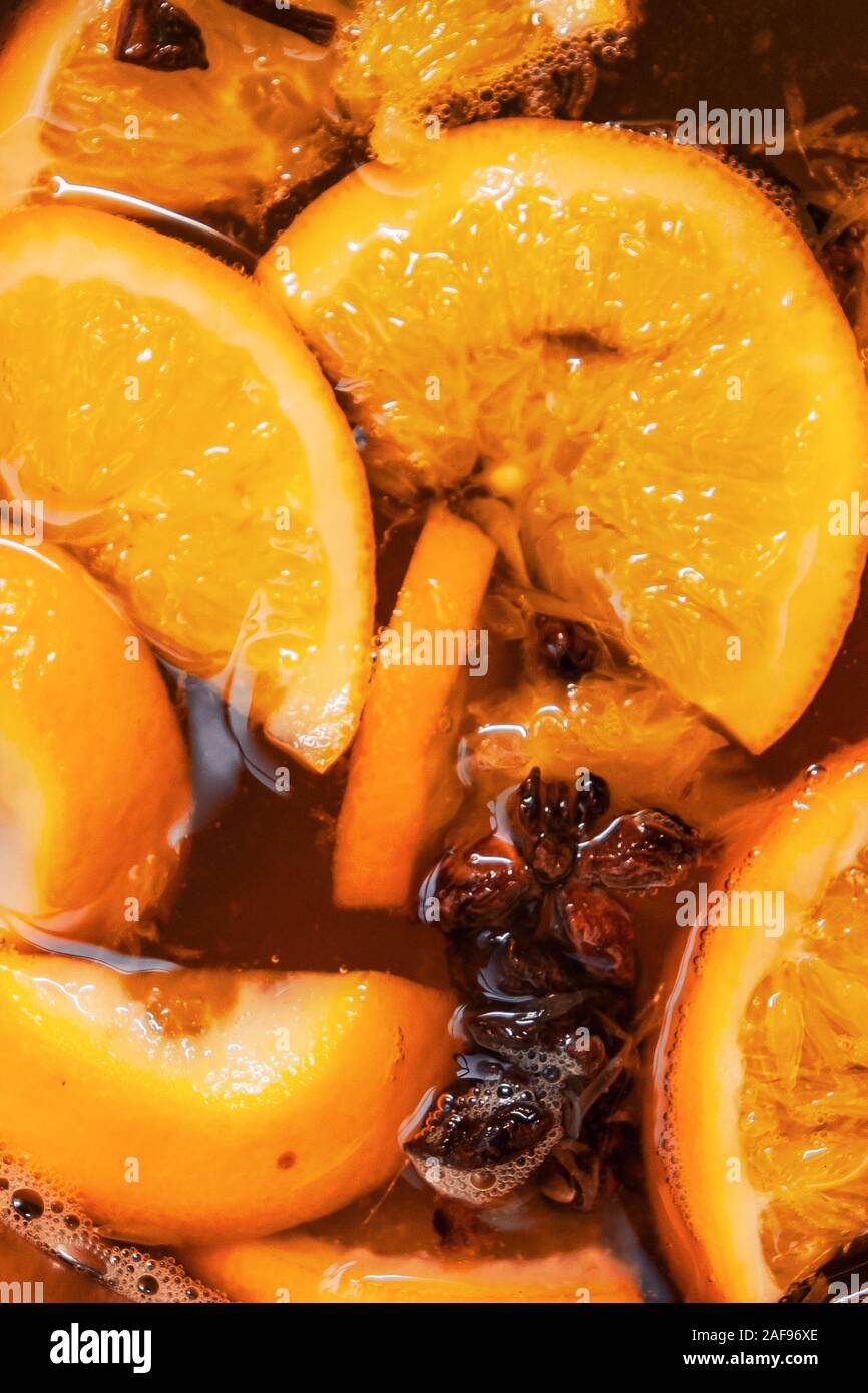 Making hot alcoholic mulled wine with oranges and spices. Christmas ...