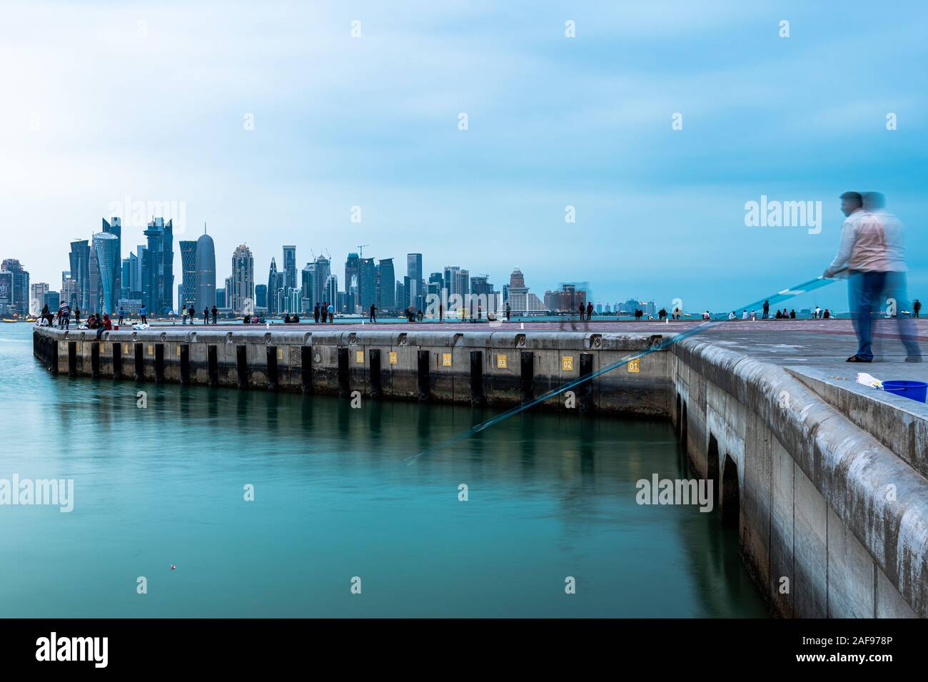 People at Doha Corniche at Doha Skyline in Background Stock Photo - Alamy