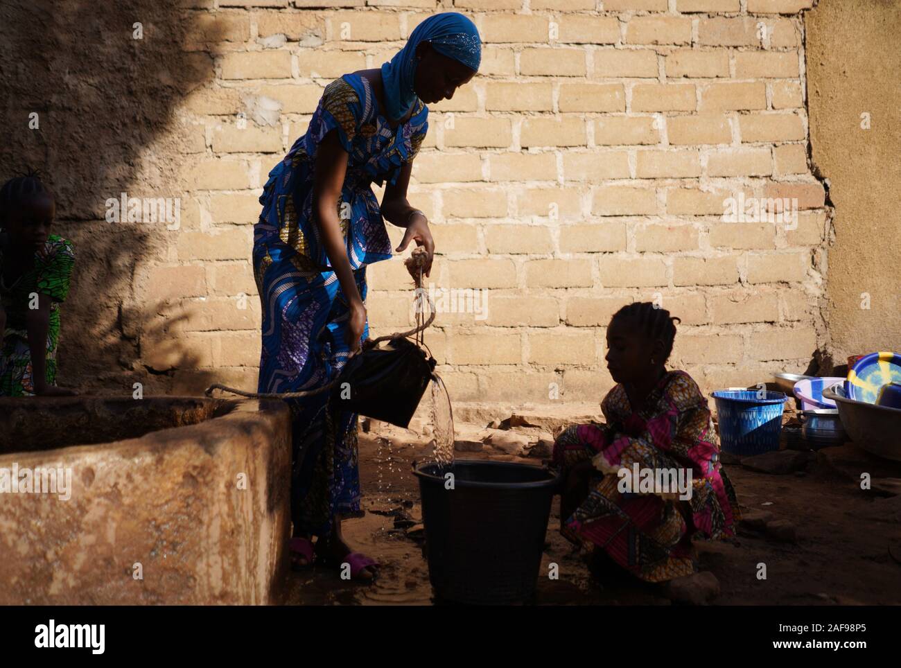 African Girl Collecting Water High Resolution Stock Photography and ...