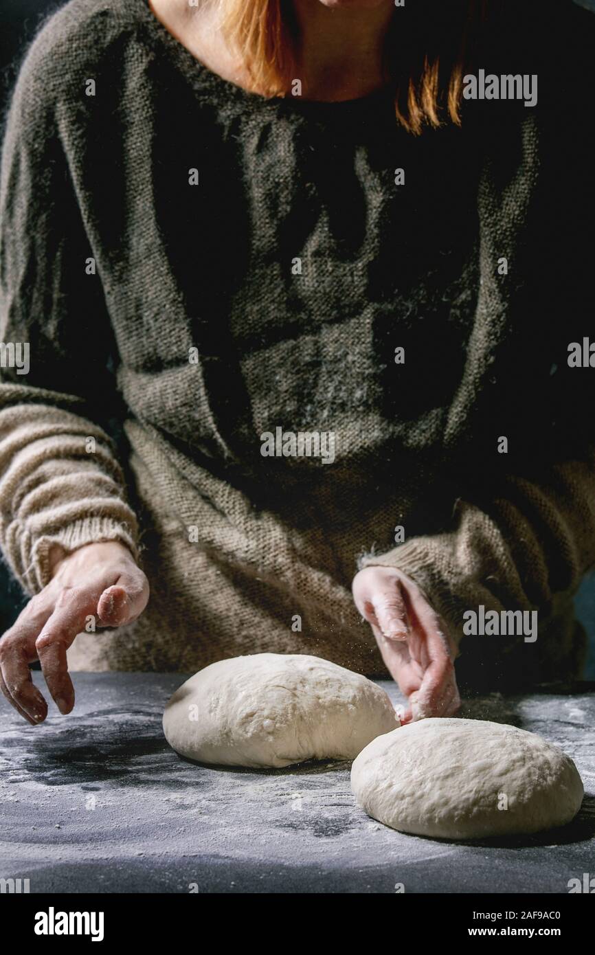 Process of making homemade bread dough. Female hands kneading dough on ...