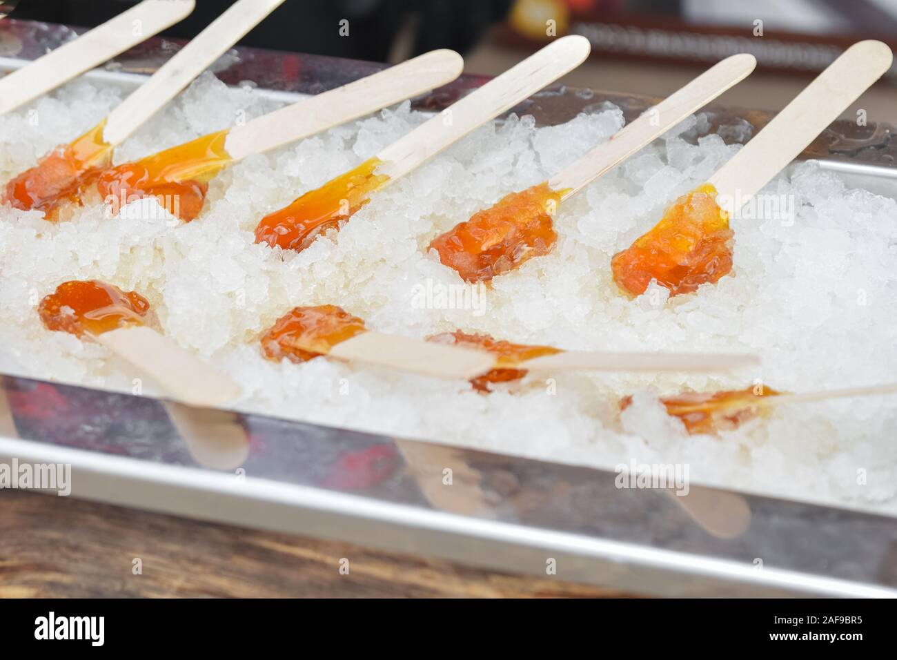 Making maple syrup on a snow. Maple syrup on a stick Stock Photo - Alamy