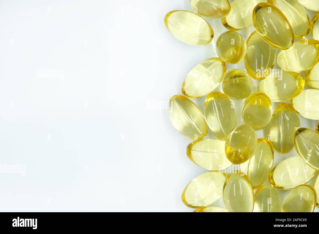Yellow transparent capsules. capsules with vitamin E. Omega 3 capsules ...