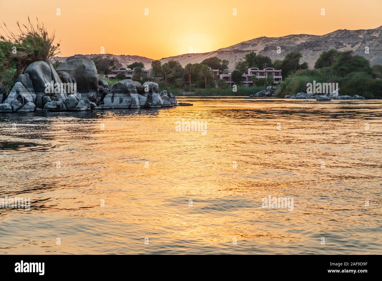 Africa, Egypt, Aswan. Sunset colors reflecting in the Nile river Stock ...