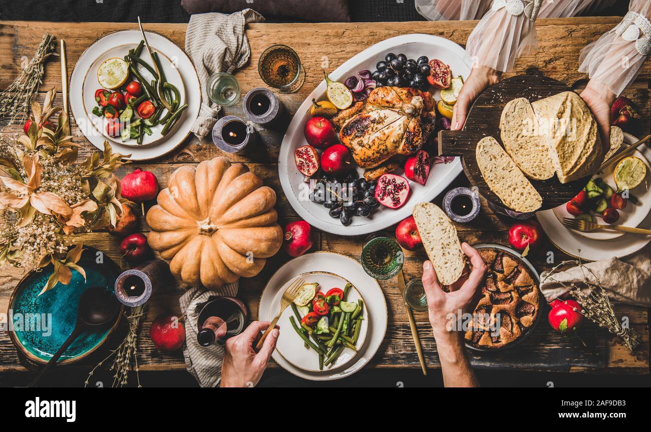 Thanksgiving party table setting. Flat-lay of whole roasted chicken ...