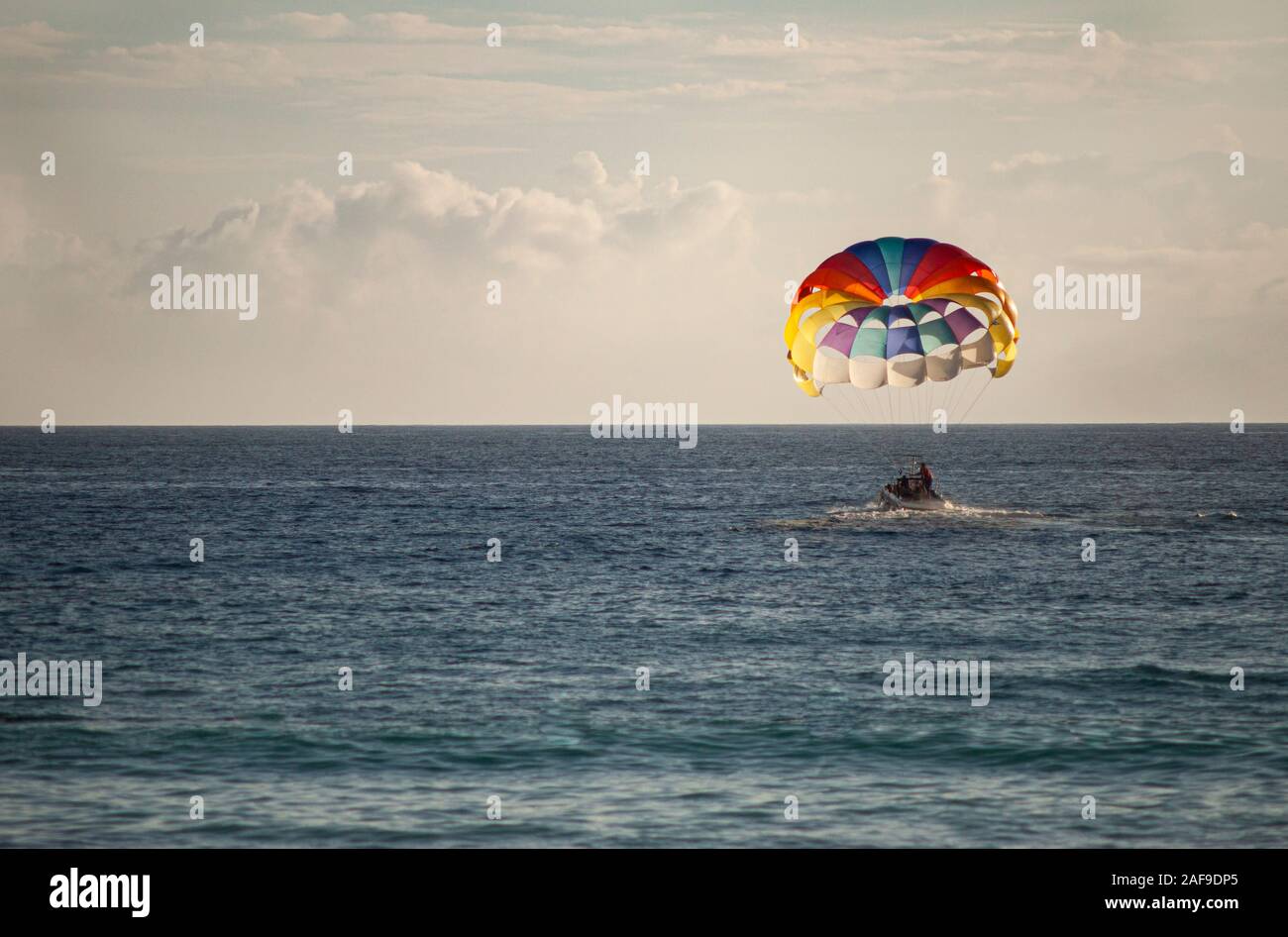 Colorful parachute on the sea at sunset Stock Photo - Alamy