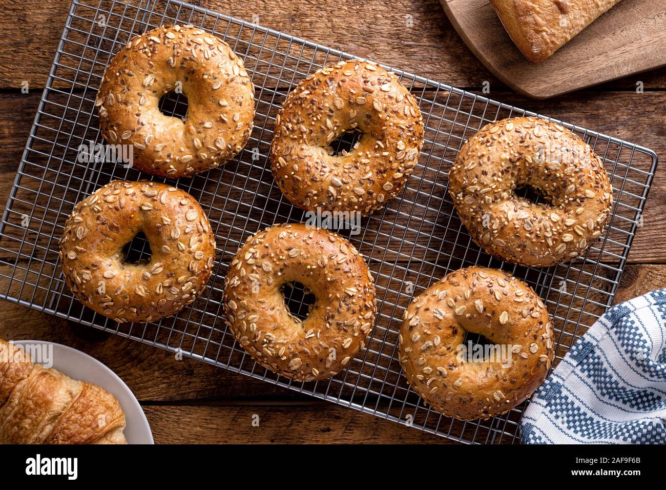 Freshly baked whole grain bagels cooling on a rack Stock Photo - Alamy