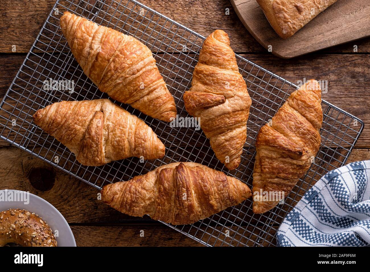 Fresh baked croissants cooling on a rack Stock Photo - Alamy
