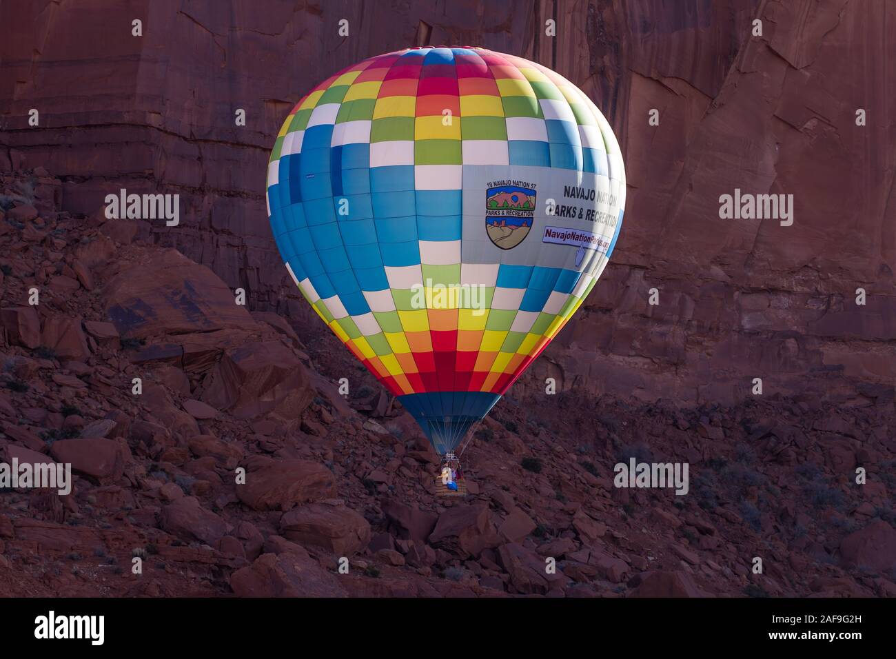 Telephoto view of a colorful checker-patterned hot air balloon at a ...