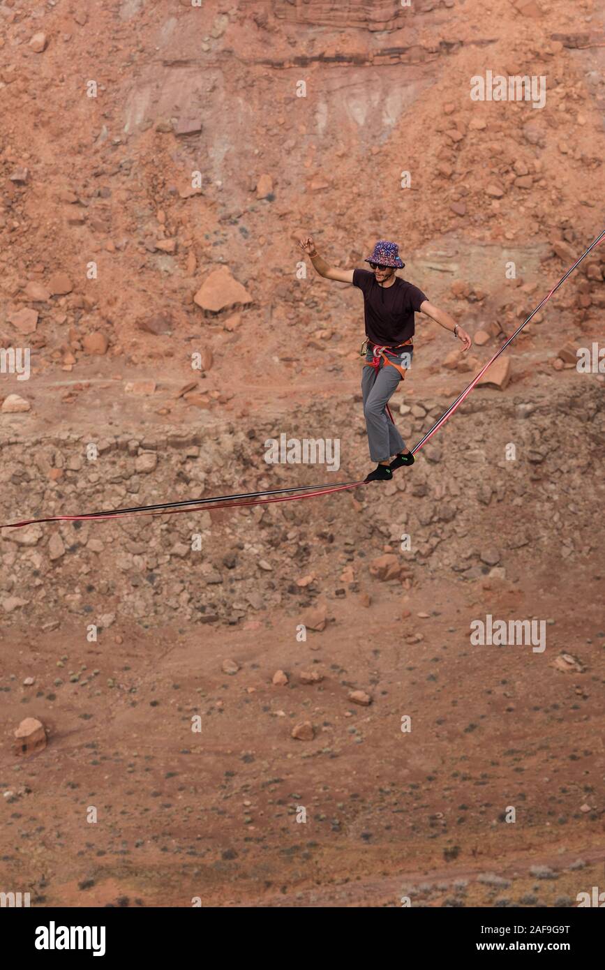 A young man slacklining or highlining hundreds of feet above Mineral ...
