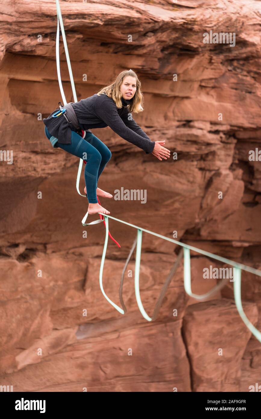 A young woman slacklining or highlining hundreds of feet above Mineral ...
