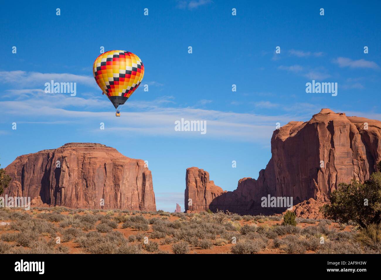 A hot air balloon flying over Cly Butte in the Monument Valley Balloon ...