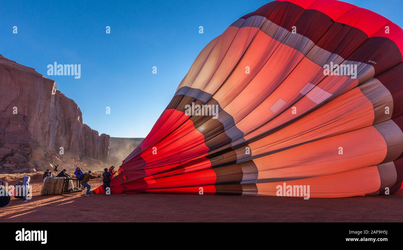 A ground crew inflates a hot balloon in preparation for launch in the ...