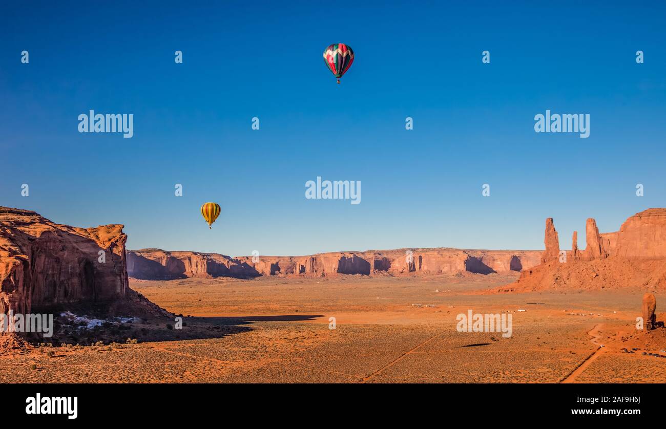 Two hot air balloons fly in the Monument Valley Balloon Festival in the ...