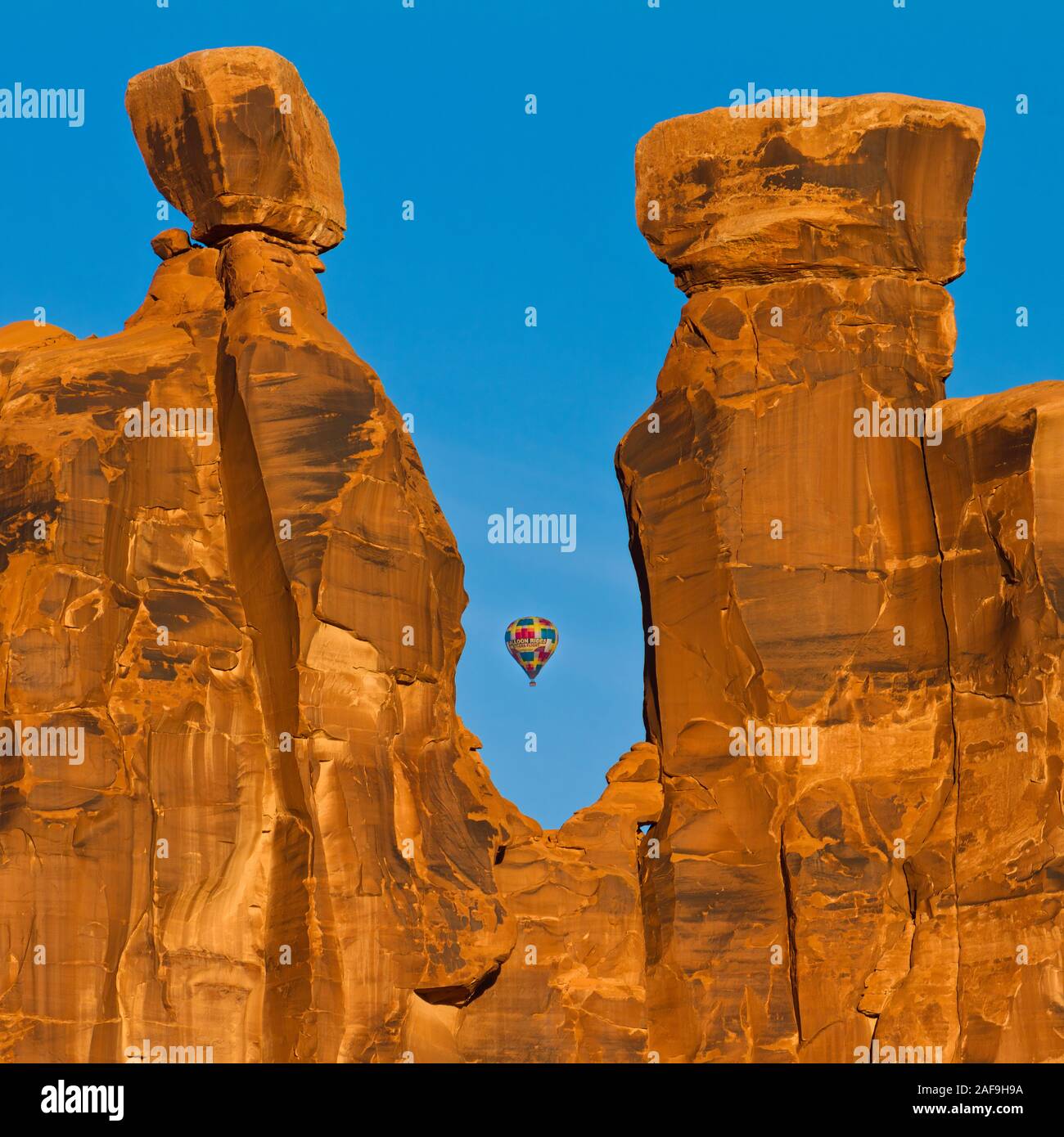 A hot air balloon flying over Arches National Park near Moab, Utah. In ...