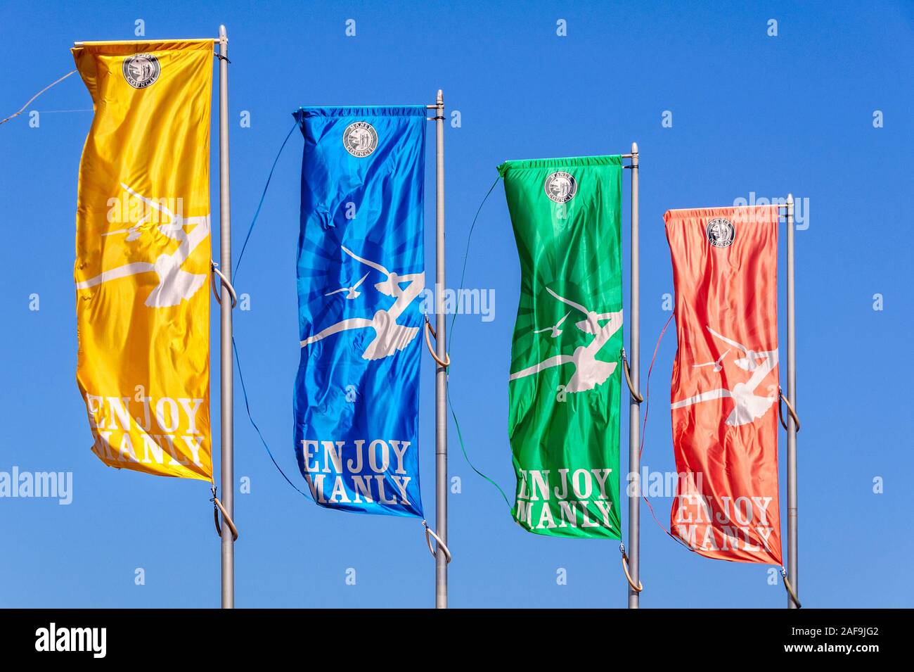 Colourful 'Enjoy Manly' flags blown by the wind - Sydney, NSW ...