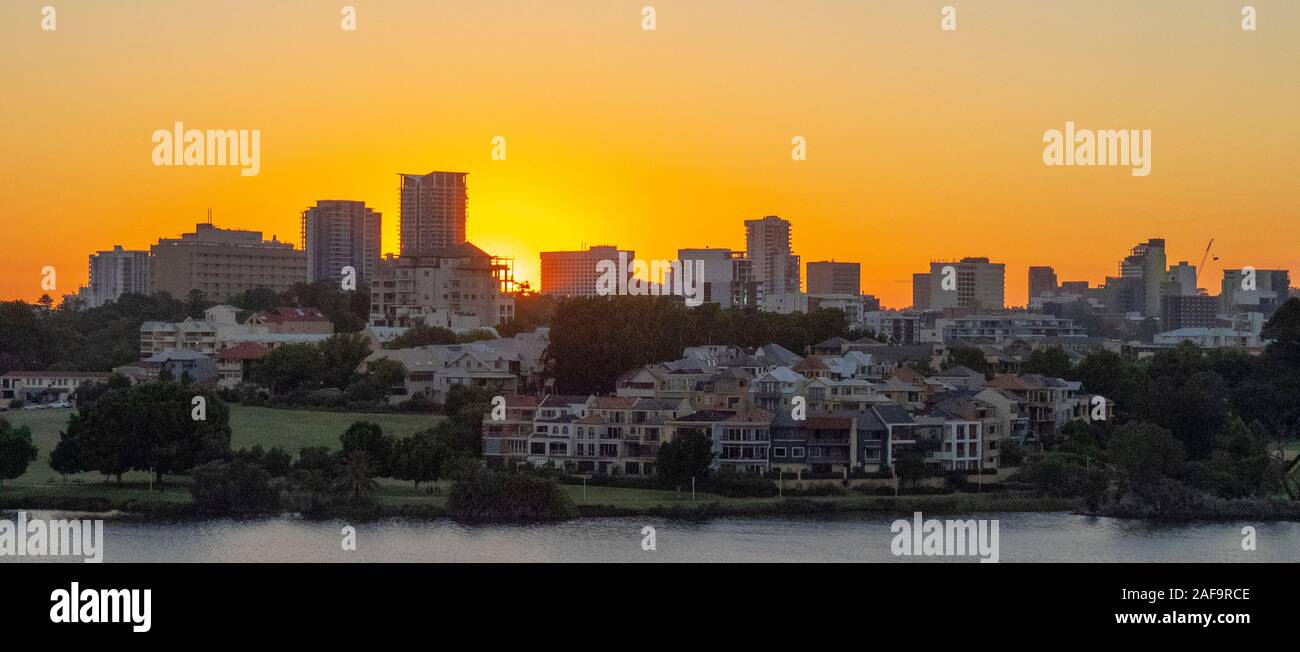 Sunset over high density low rise residential houses alongside the Swan ...