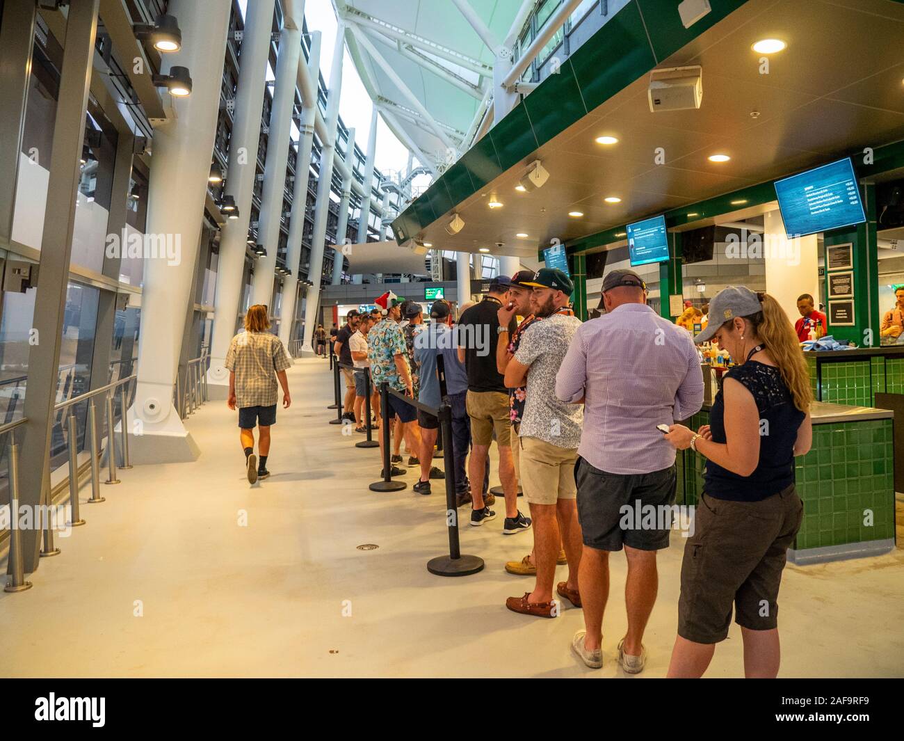 Cricket fans queuing to buy beer at a bar at Optus Stadium Perth ...