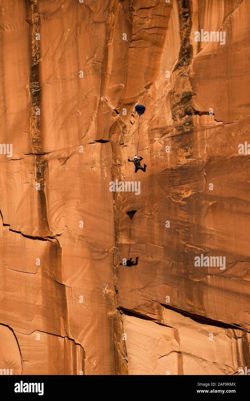 A BASE jumper leaps off the 400 foot vertical face of the Tombstone in ...
