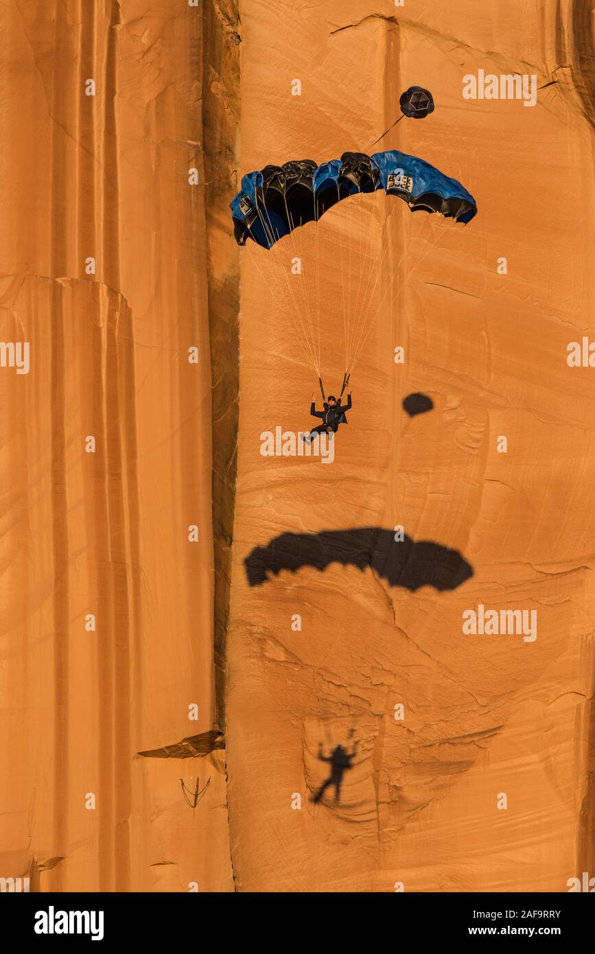 A BASE jumper descends in his parachute off the 400 foot vertical face ...