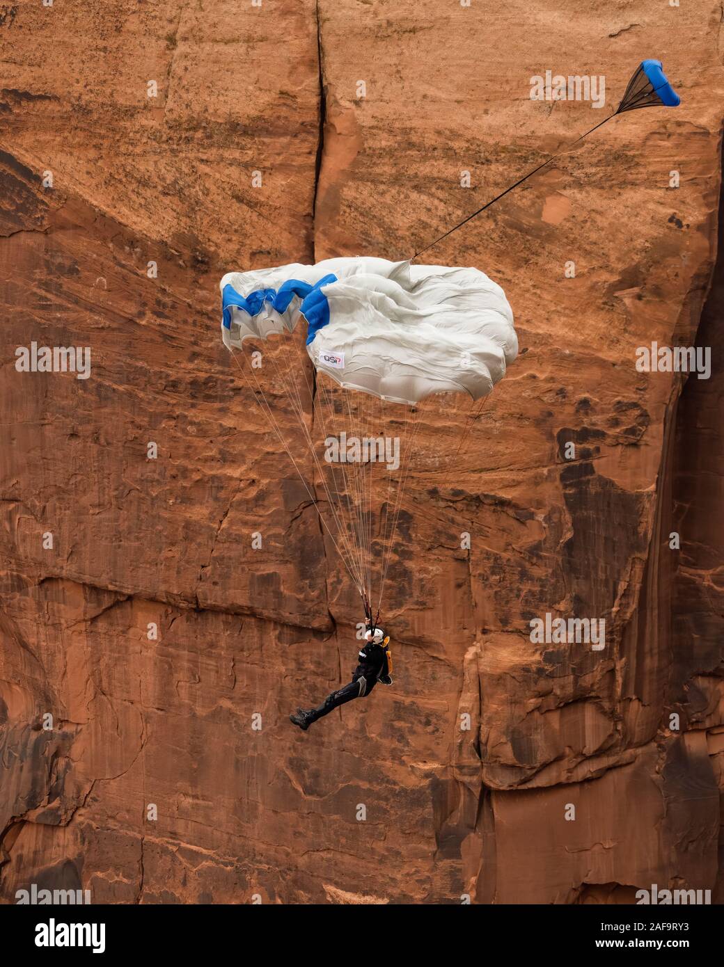 A BASE jumper descends in his parachute from the cliffs 950 vertical ...