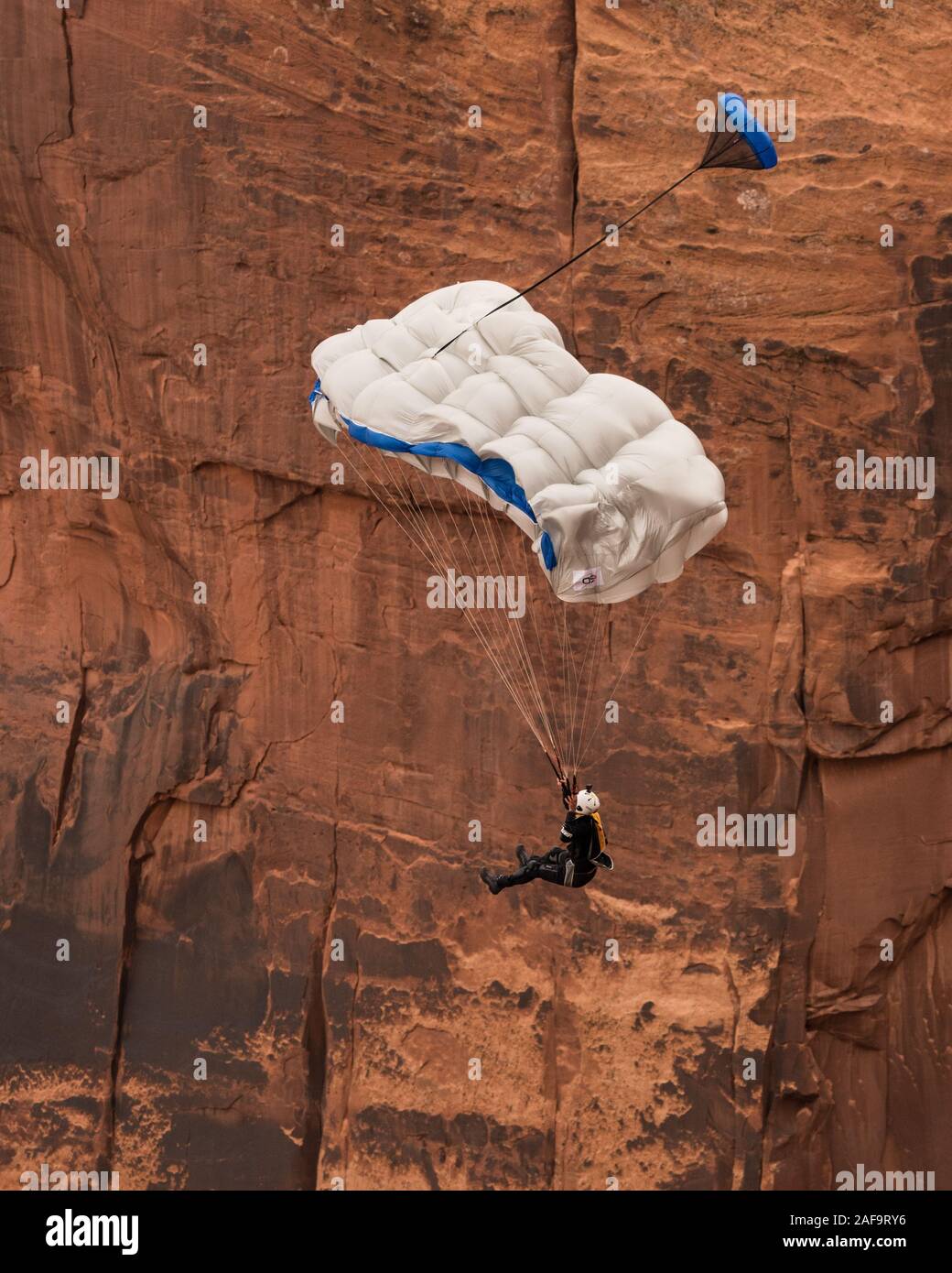A BASE jumper descends in his parachute from the cliffs 950 vertical ...