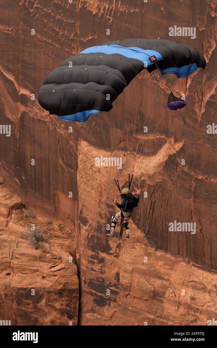 A BASE jumper descends in his parachute from the cliffs 950 vertical ...