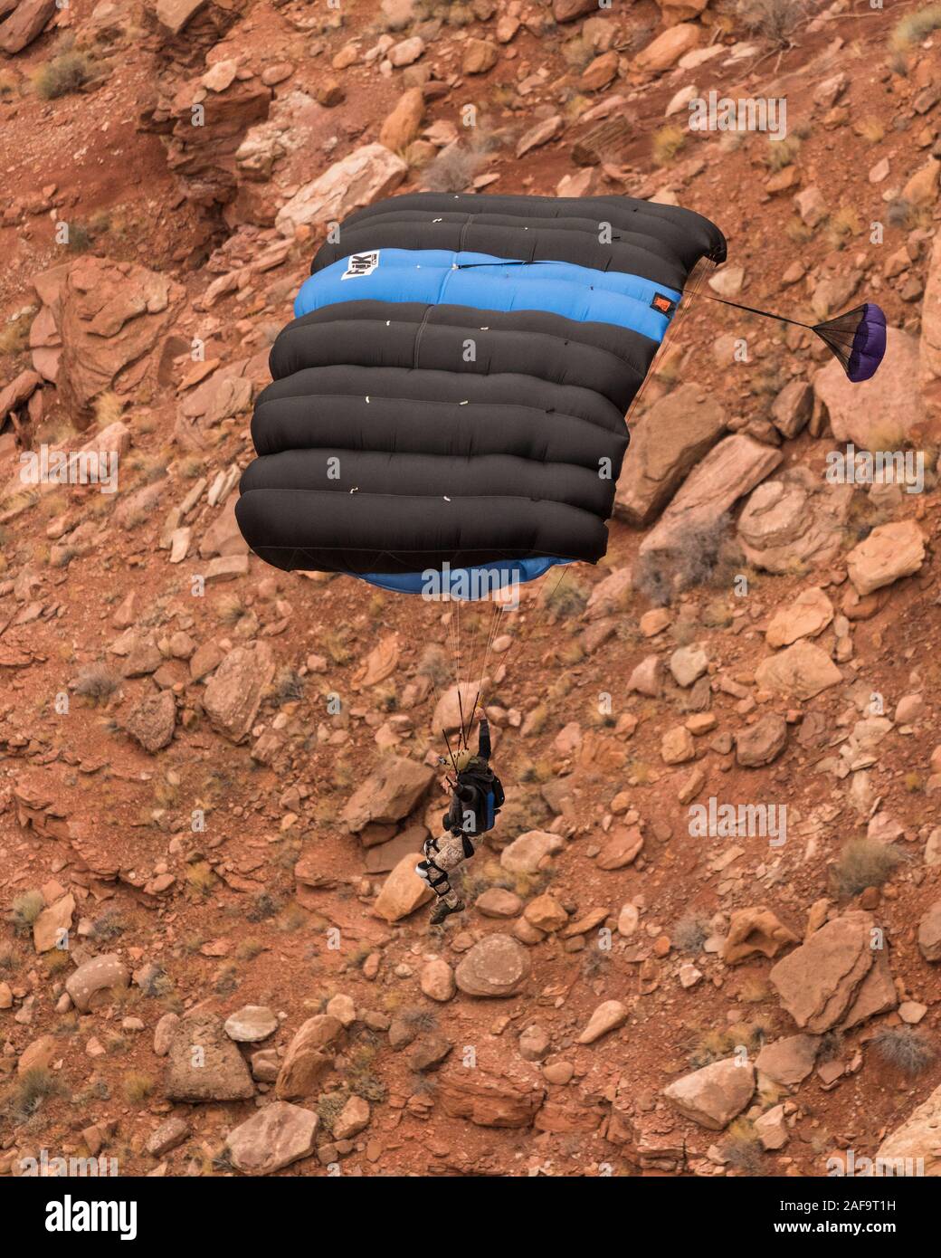 A BASE jumper descends in his parachute from the cliffs 950 vertical ...