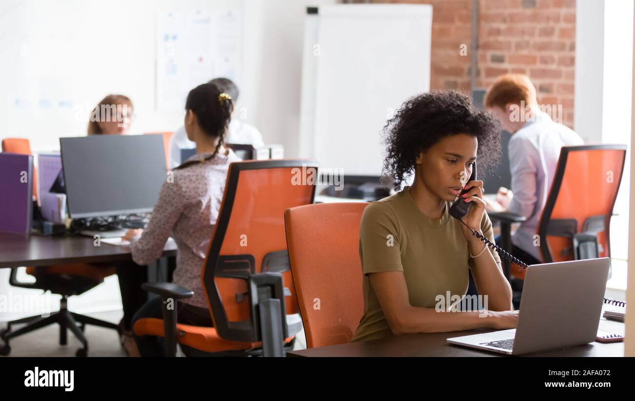 Diverse employees working in modern room sitting in shared office Stock ...