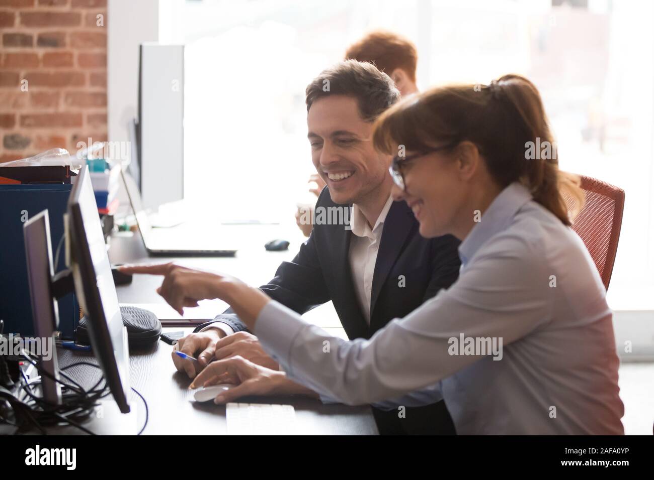 Different ages employees sitting in shared office room working together ...