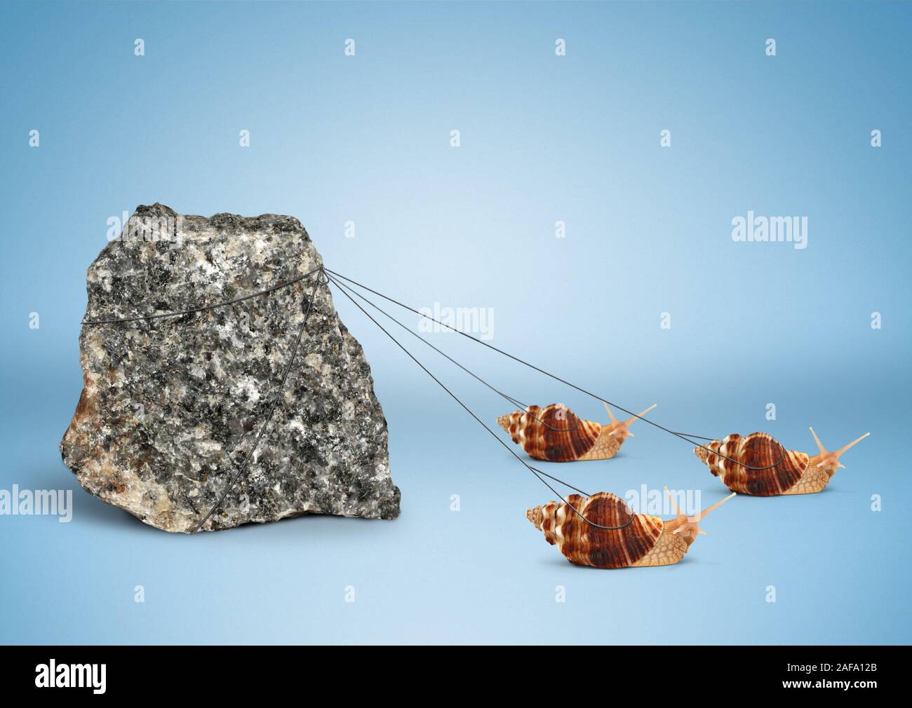 Team work concept, snails pulling big rock Stock Photo - Alamy