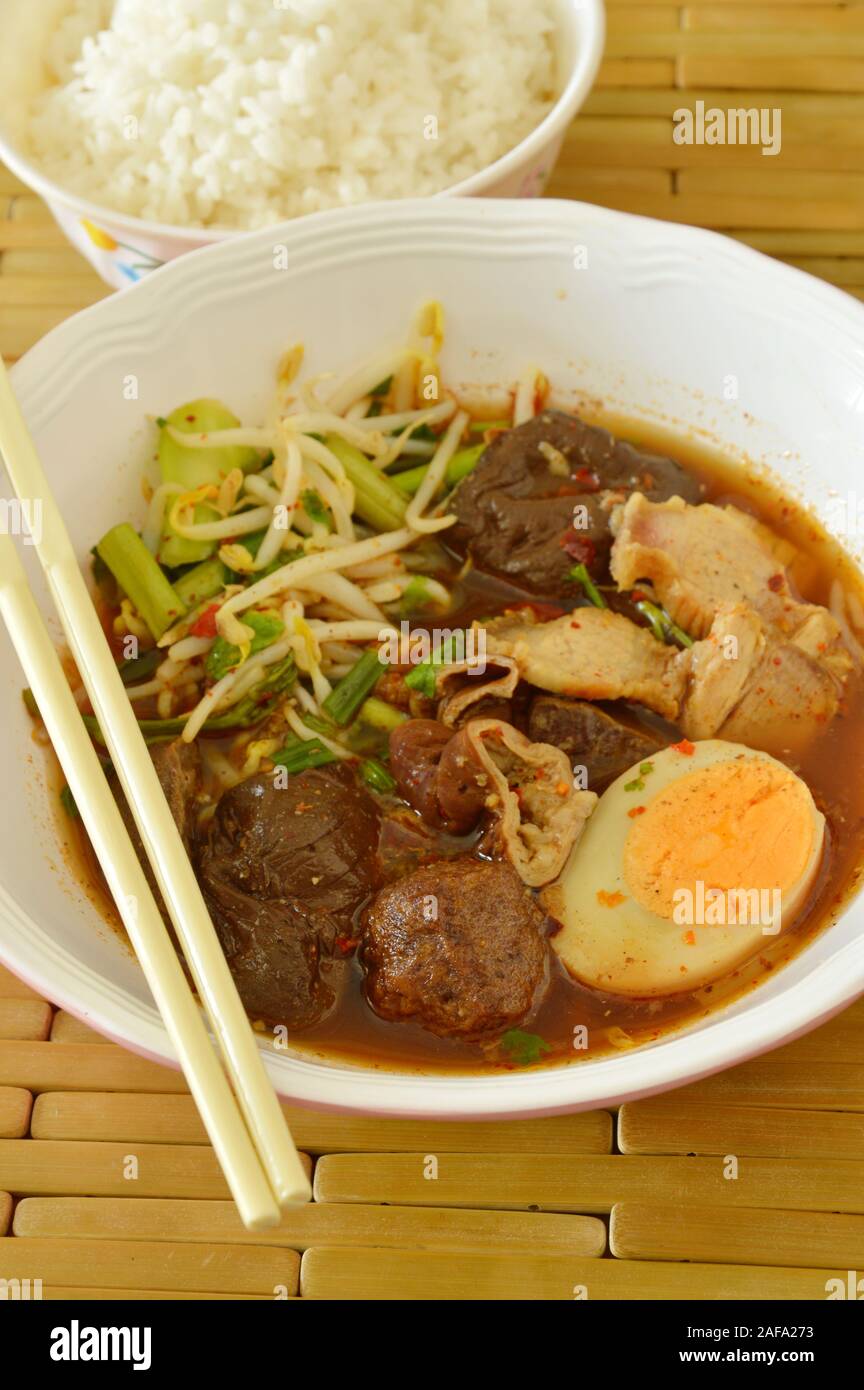boiled pork entrails topping egg in brown soup eat couple with rice ...