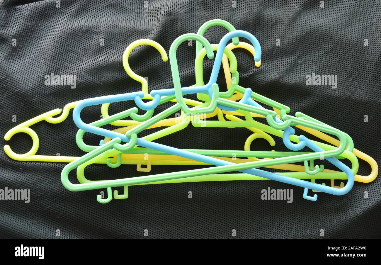 colorful plastic clothes hunger on black fabric Stock Photo - Alamy