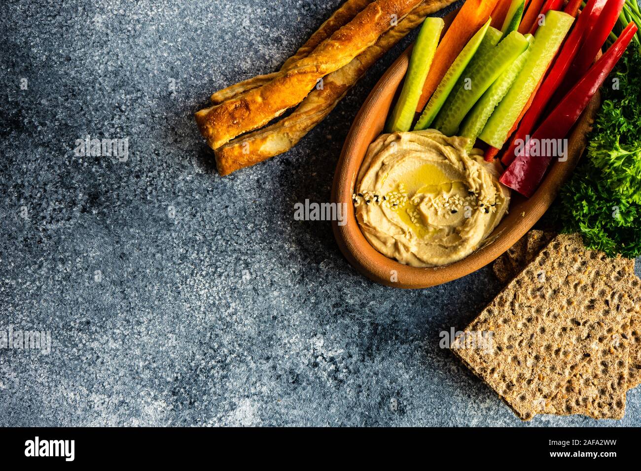 Traditional chickpeas hummus with olive oil and sesame seeds on stone ...
