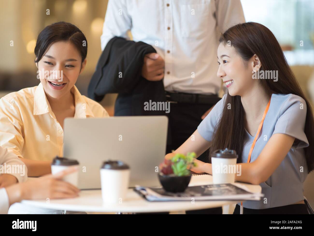 Young Asian woman and business people are meeting in office discussion ...