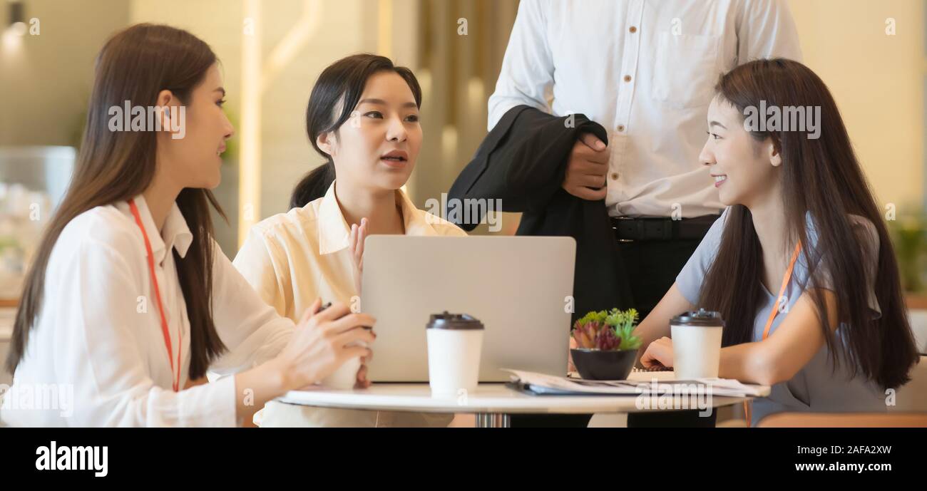Young Asian woman and business people are meeting in office discussion ...