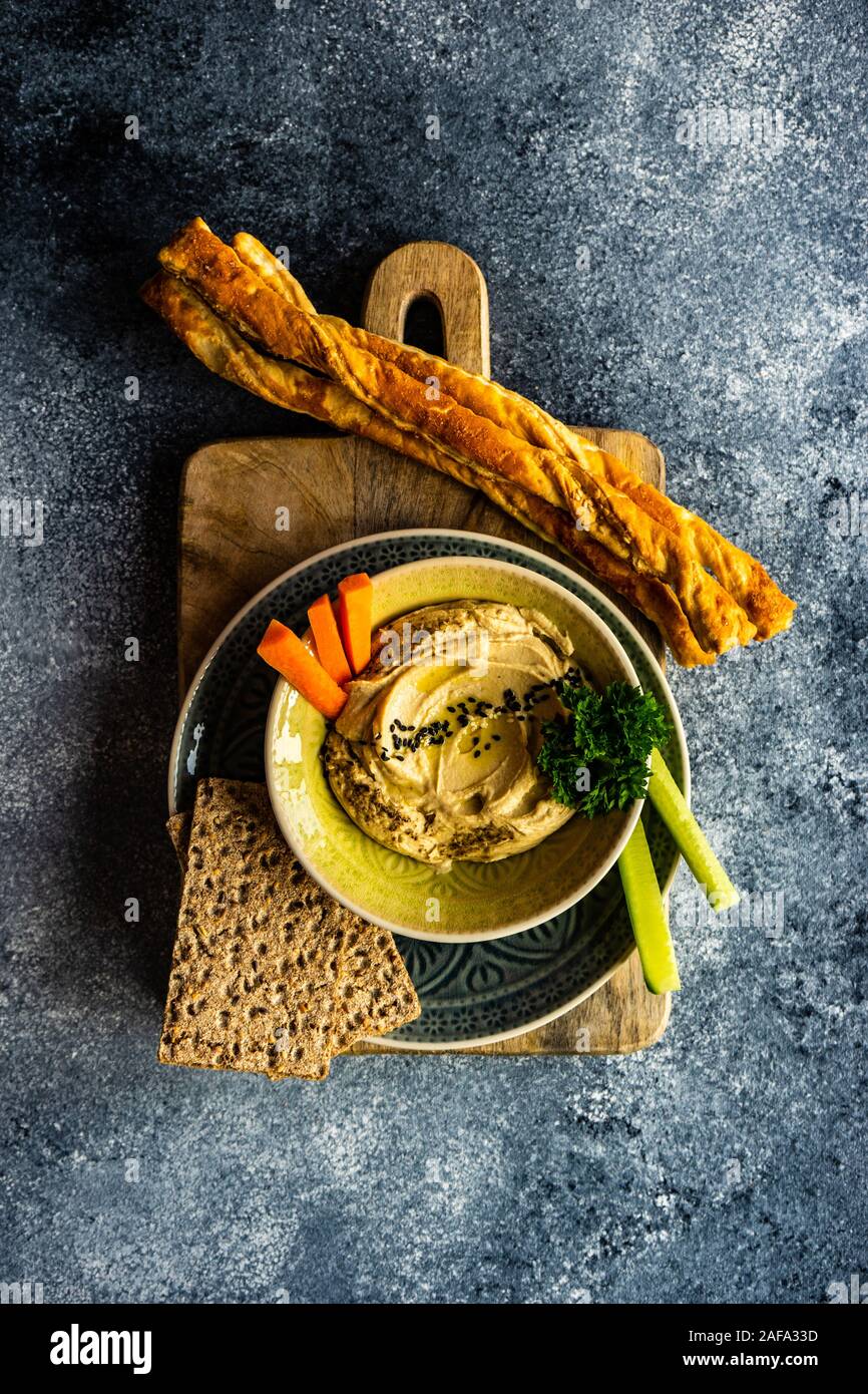 Traditional chickpeas hummus with olive oil and sesame seeds on stone ...