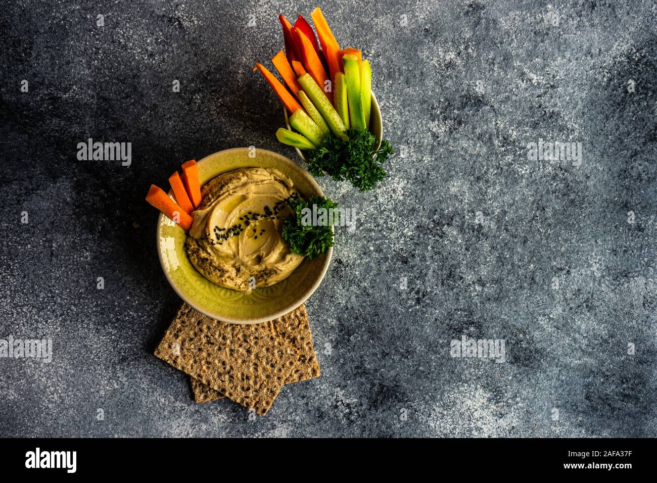 Traditional chickpeas hummus with olive oil and sesame seeds on stone ...