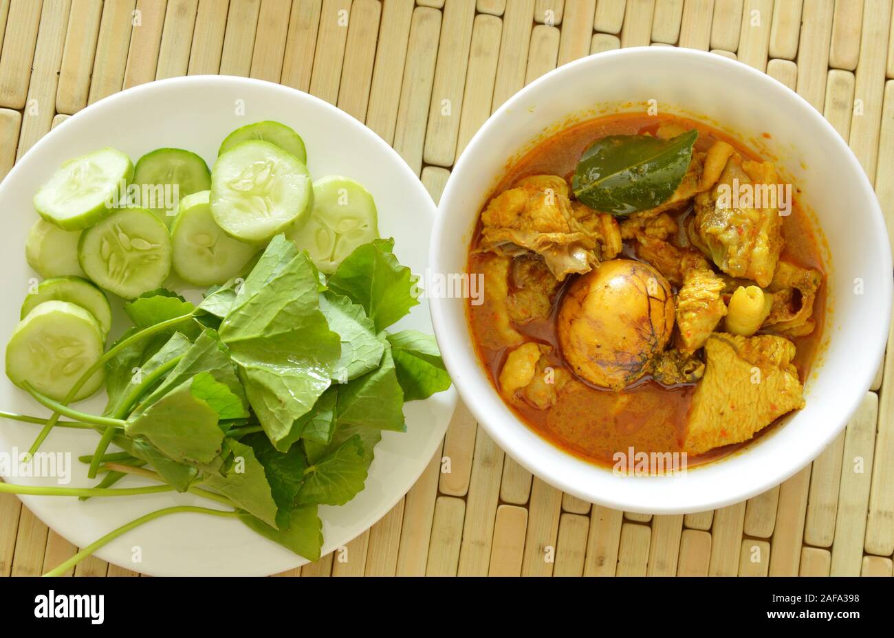 spicy chicken with egg spoiled while being incubated curry in cup Stock ...