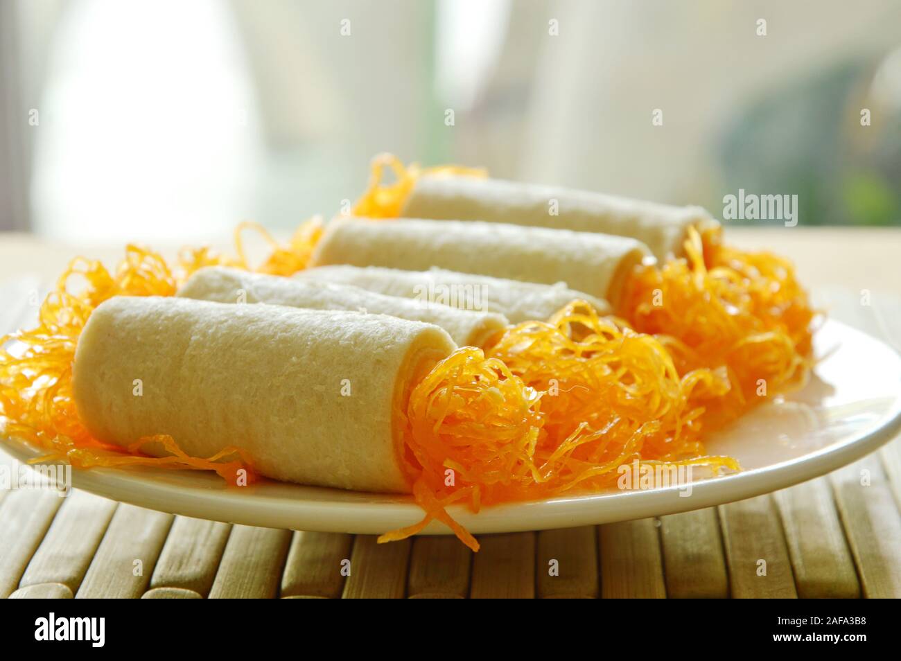 bread roll golden threads applied dessert on plate Stock Photo - Alamy