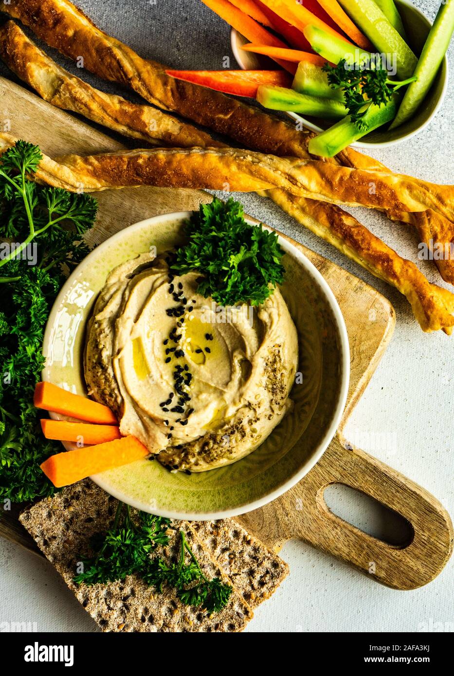 Traditional chickpeas hummus with olive oil and sesame seeds on stone ...