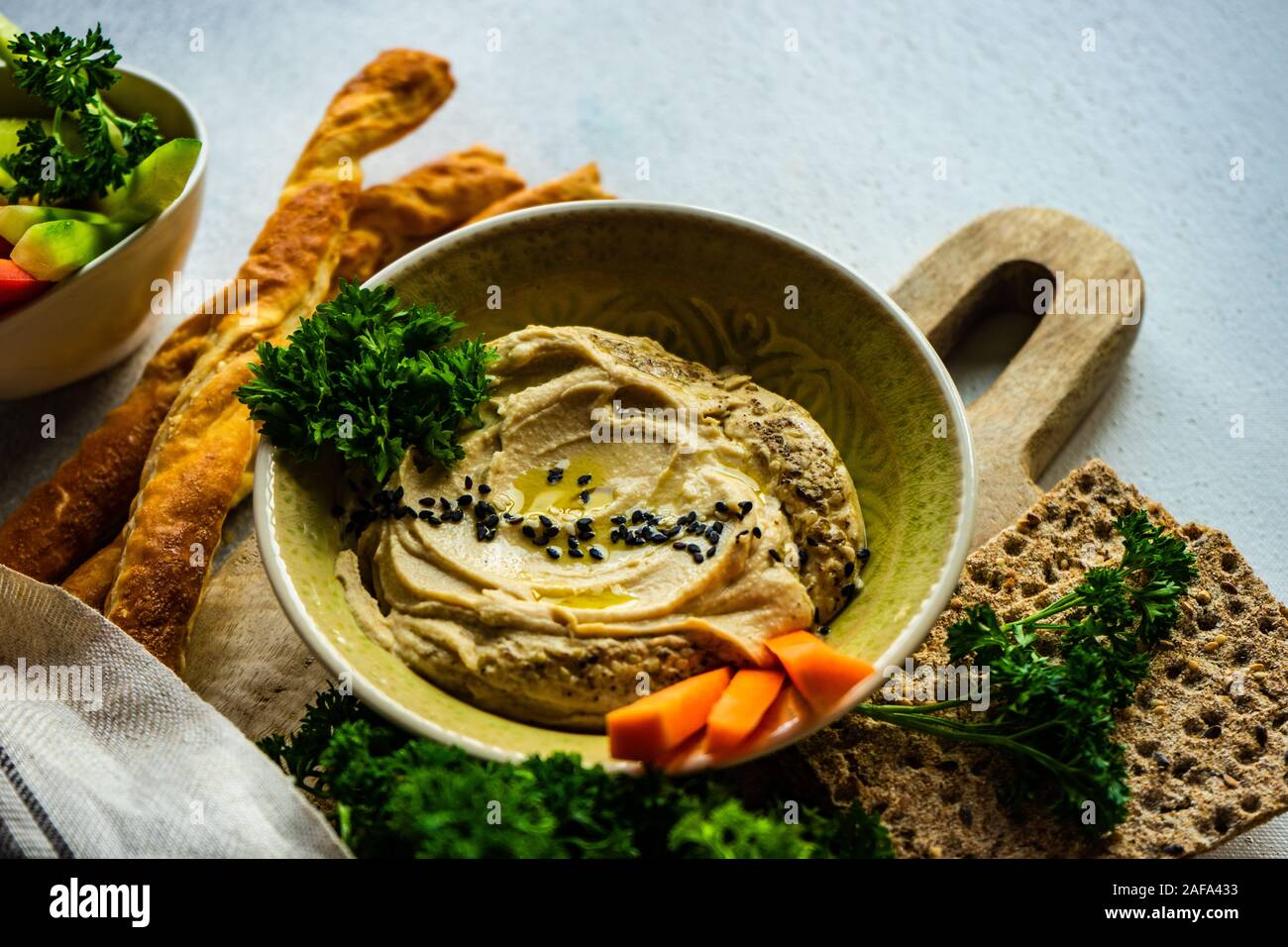 Traditional chickpeas hummus with olive oil and sesame seeds on stone ...