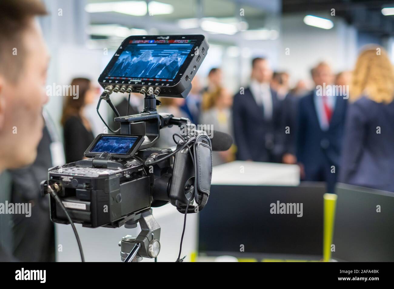 Cameraman shoots video of business meeting, focus on camera Stock Photo ...