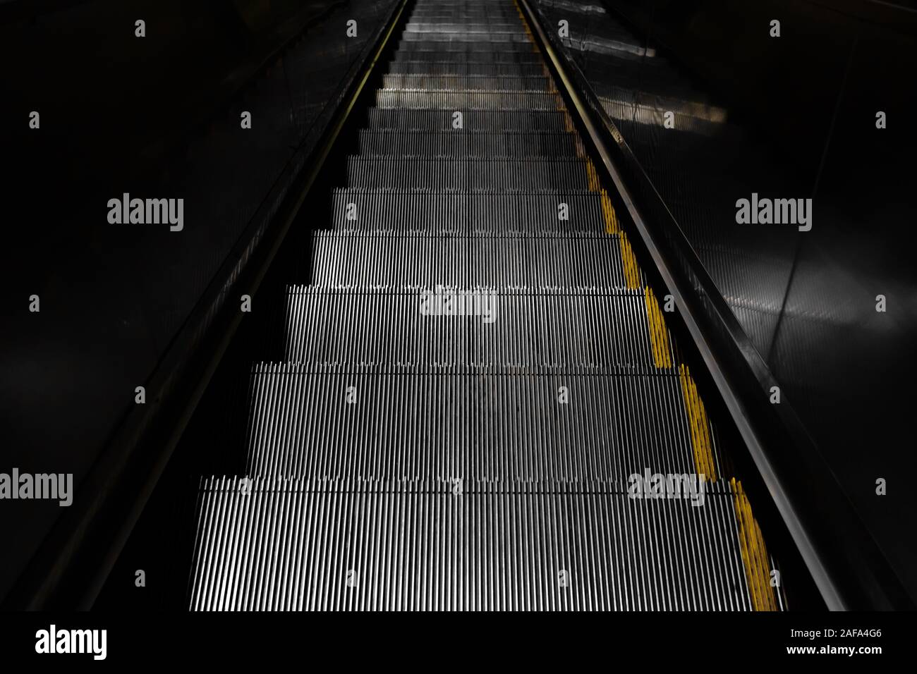 Escalator in an underground station dark background Stock Photo - Alamy
