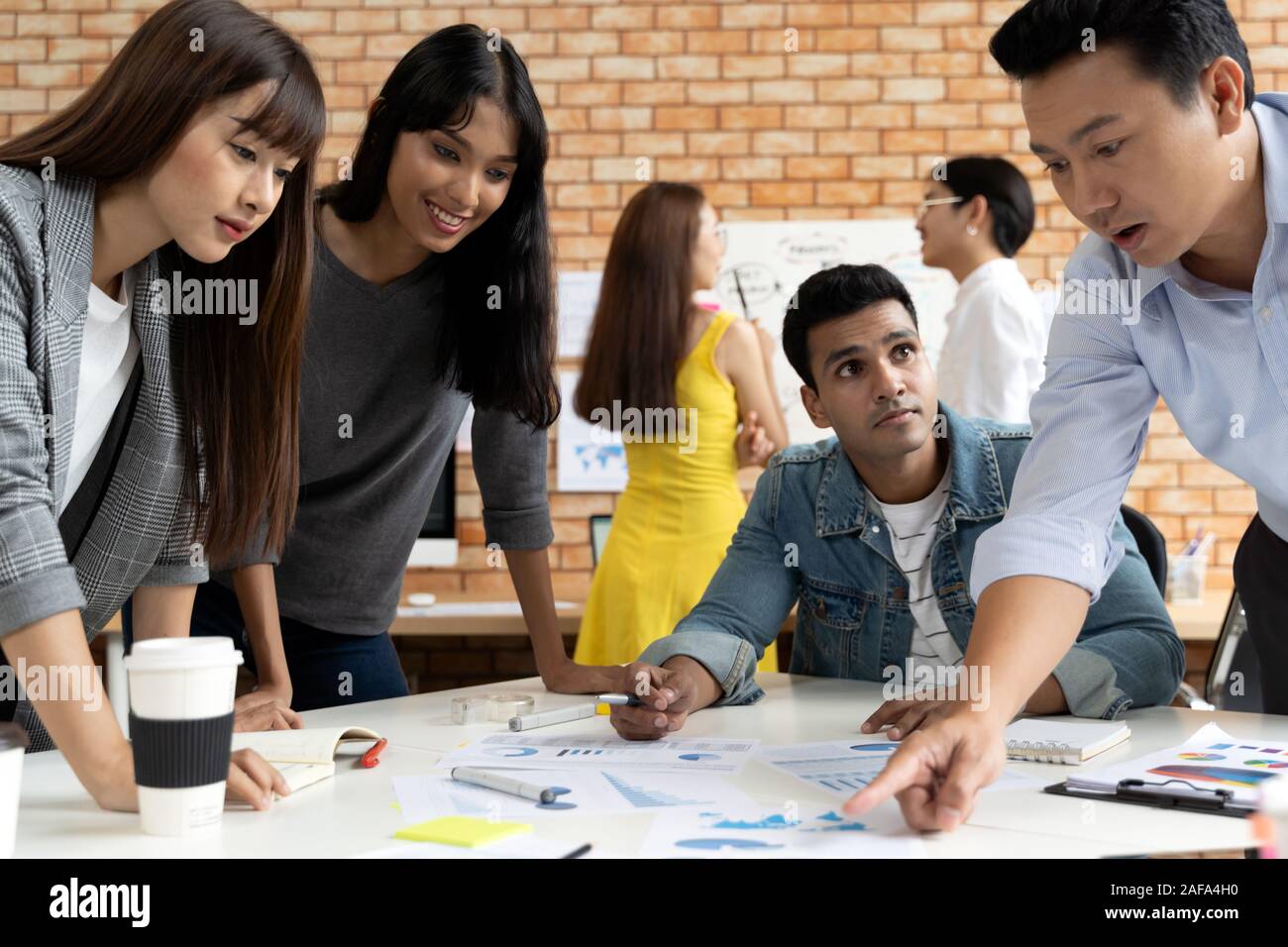 Group of Asian business people team meeting in modern office working ...