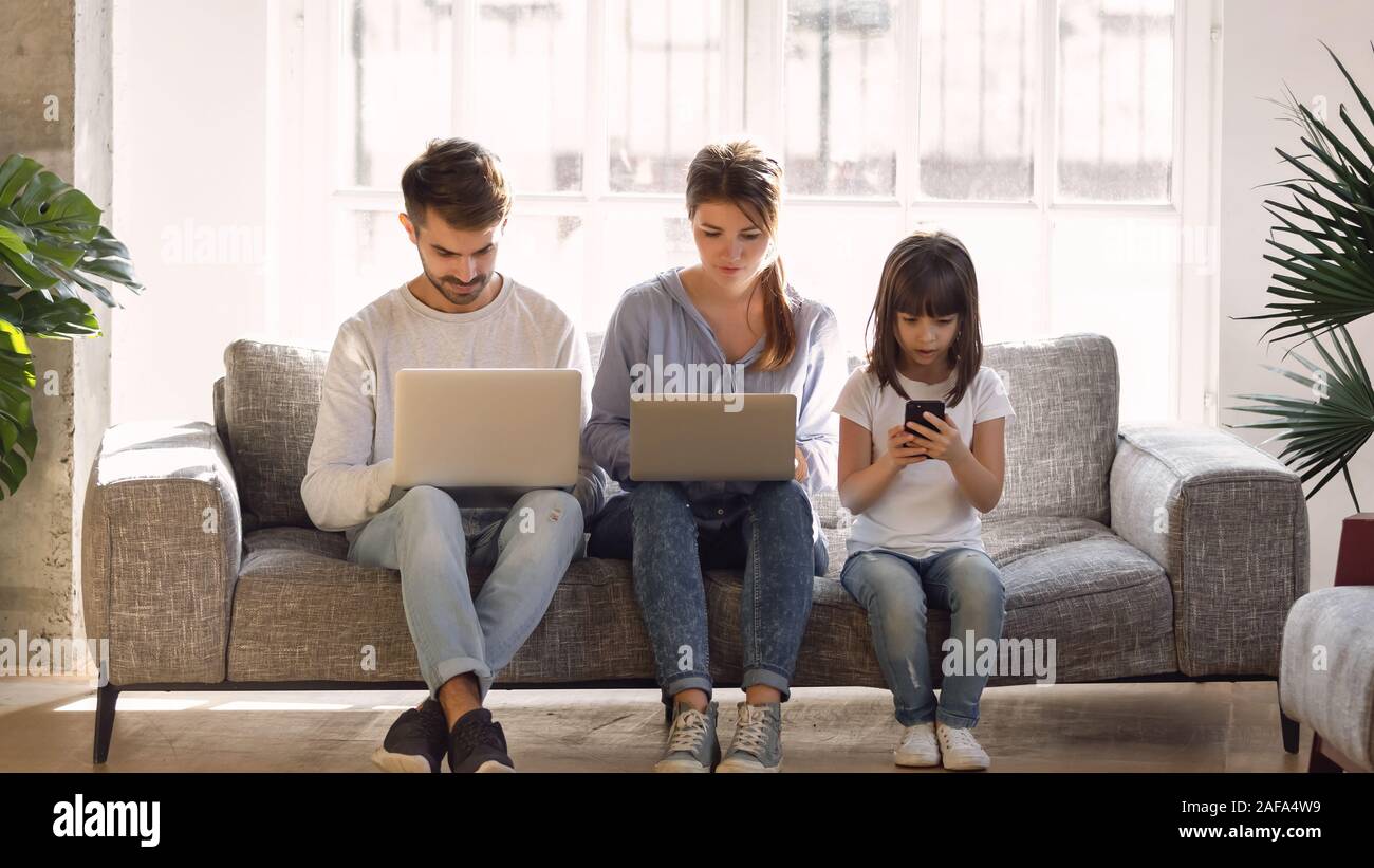Family with daughter using laptops and smartphone, gadget addiction ...